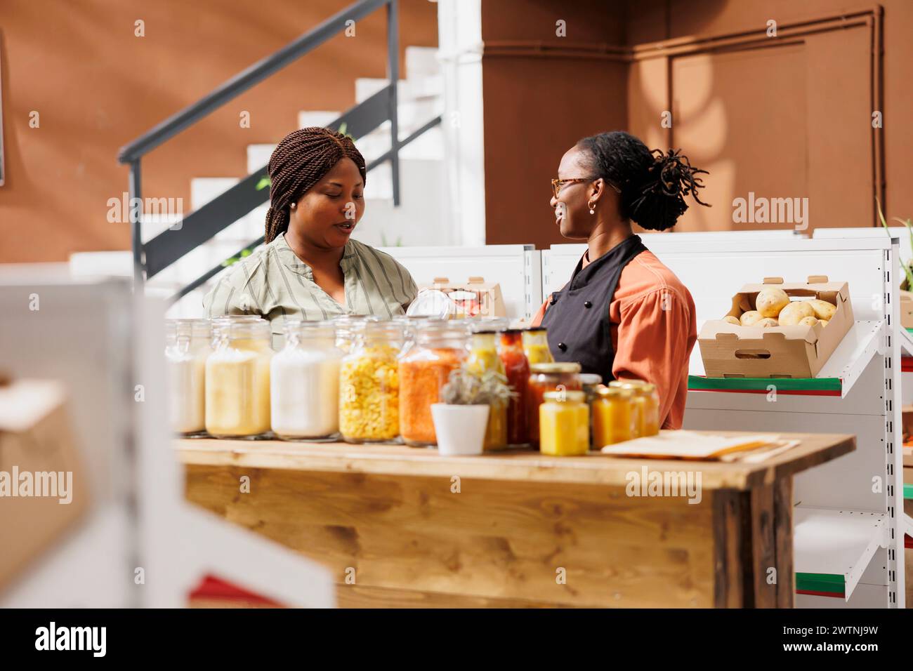 Female merchant showcasing her products in zero waste marketplace venue ...