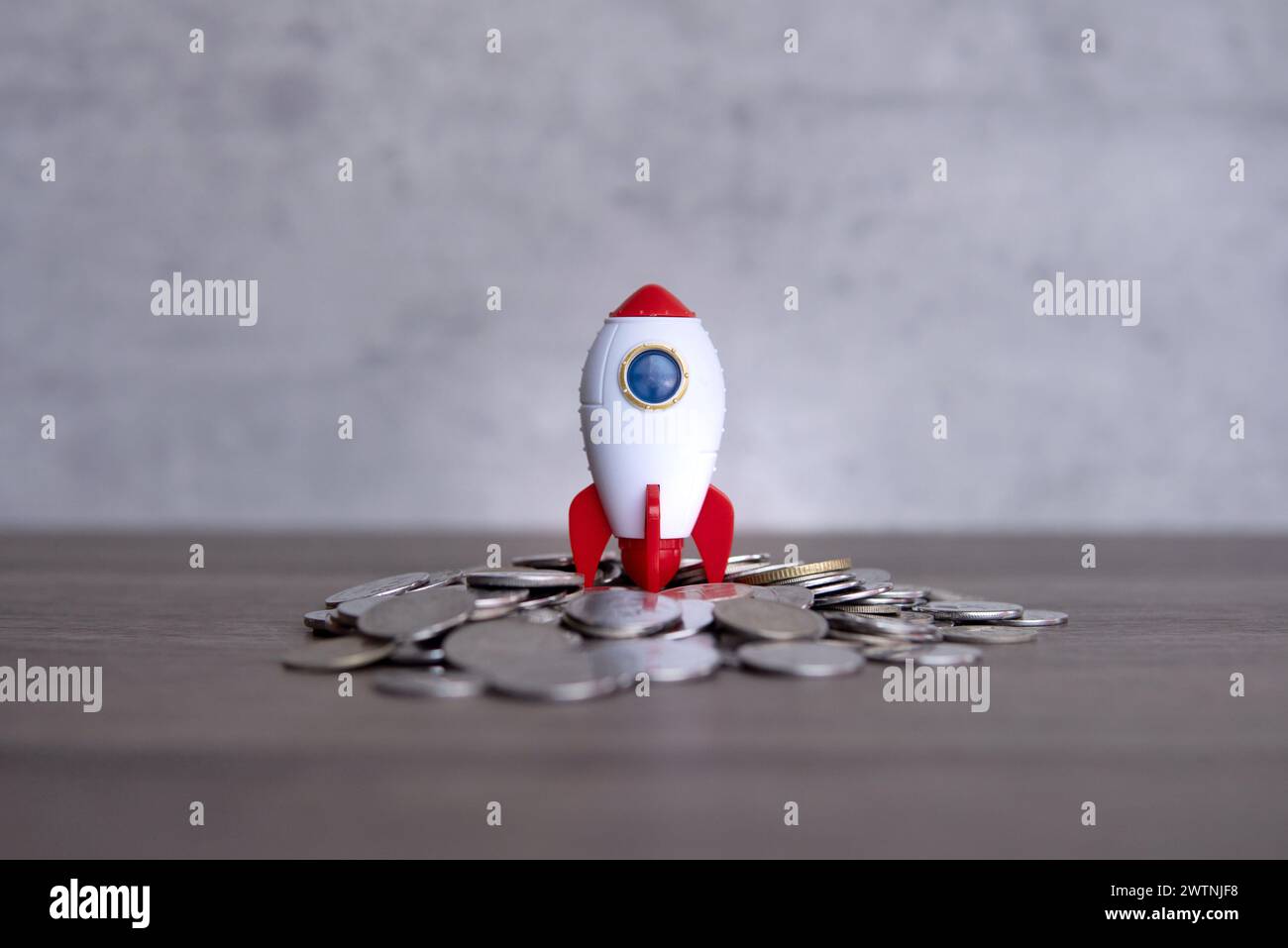 Closeup image of rocket spaceship and coins. Business startup, launch ...