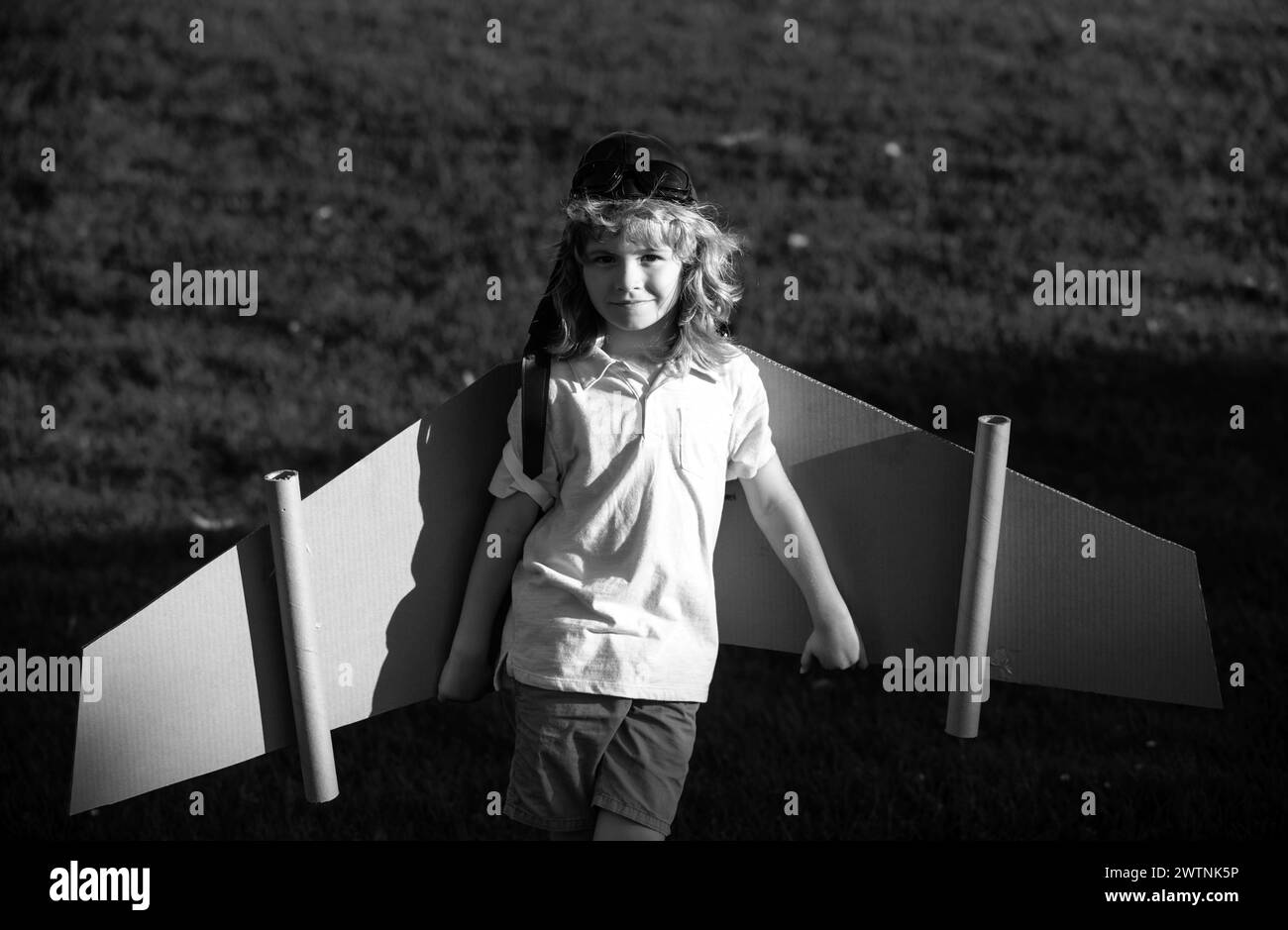 Funny boy with toy cardboard airplane wings fly. Startup freedom ...