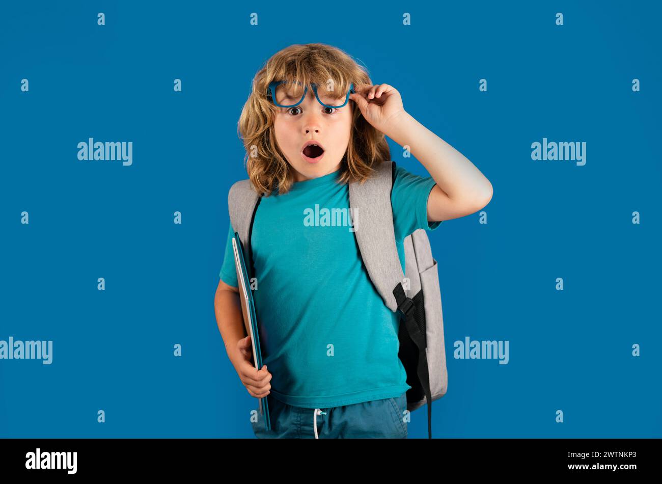 Back to school. School child with book on isolated background ...