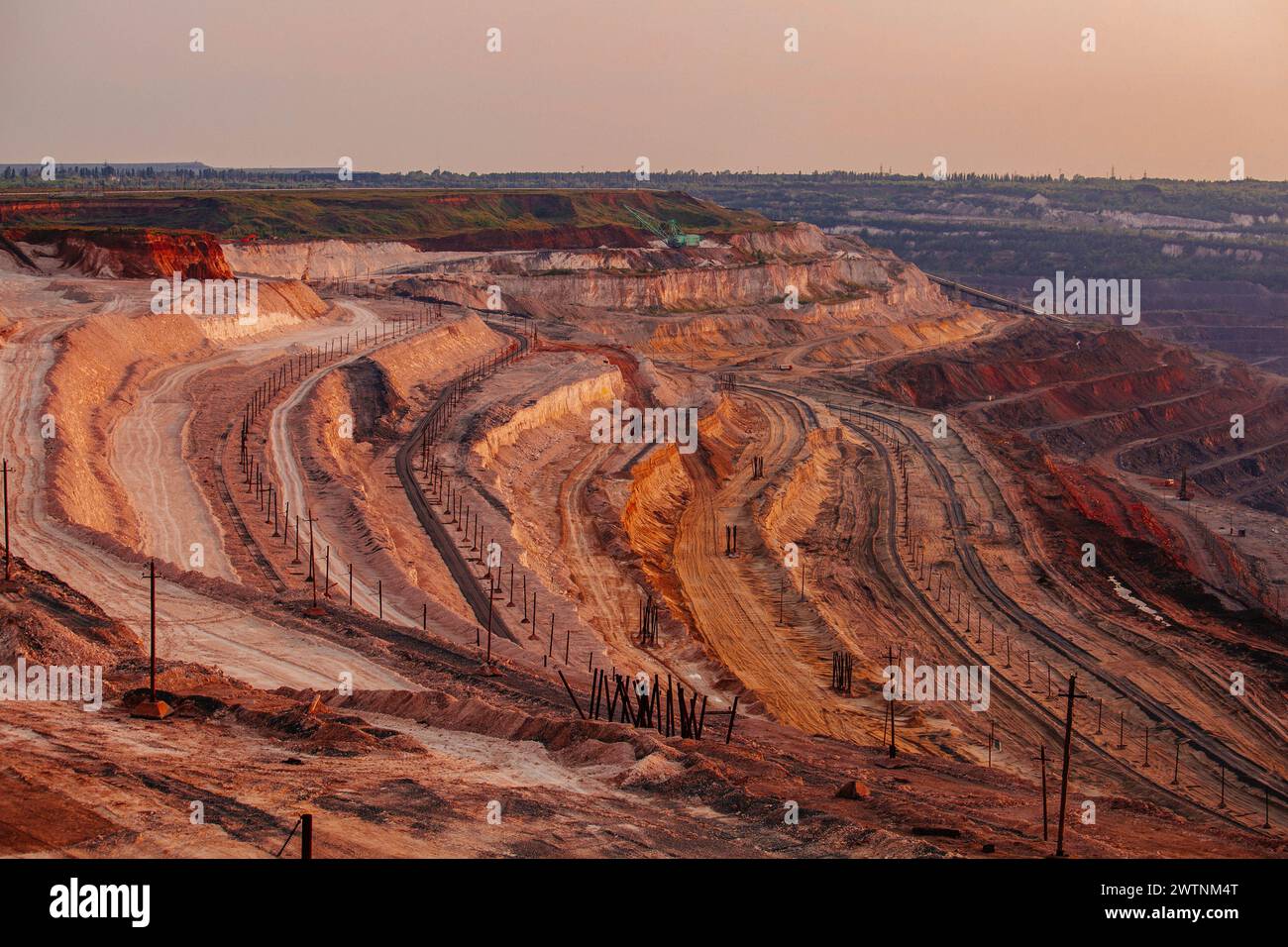 Excavators and dump trucks working on earthmoving at open pit mine in ...