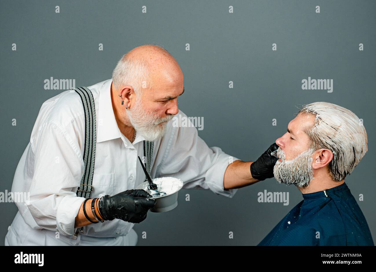 Man color hair in barbershop. Process of a man hair coloring at barber ...