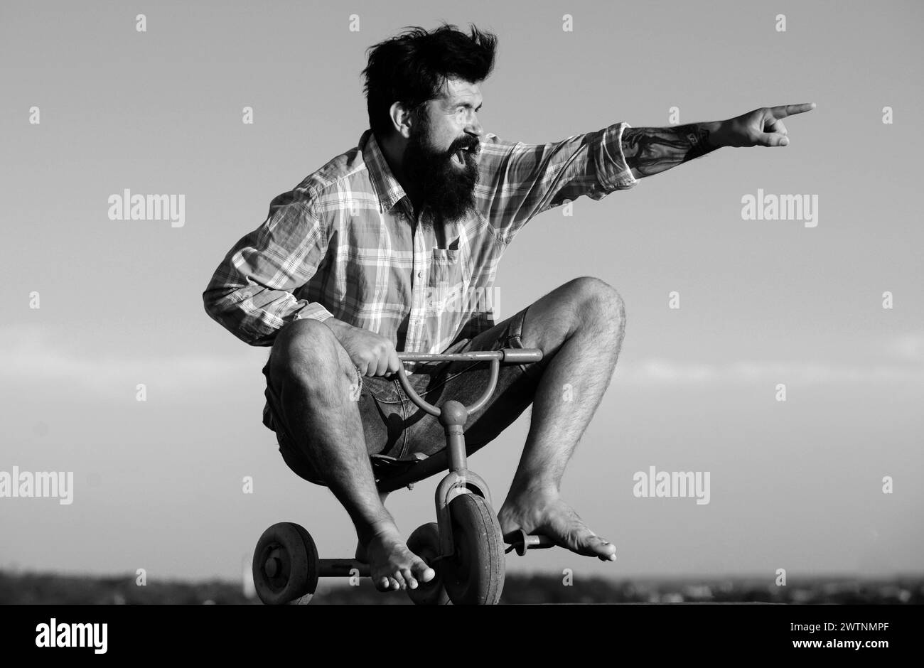 Crazy man riding a small bicycle. Excited young male riding a small ...