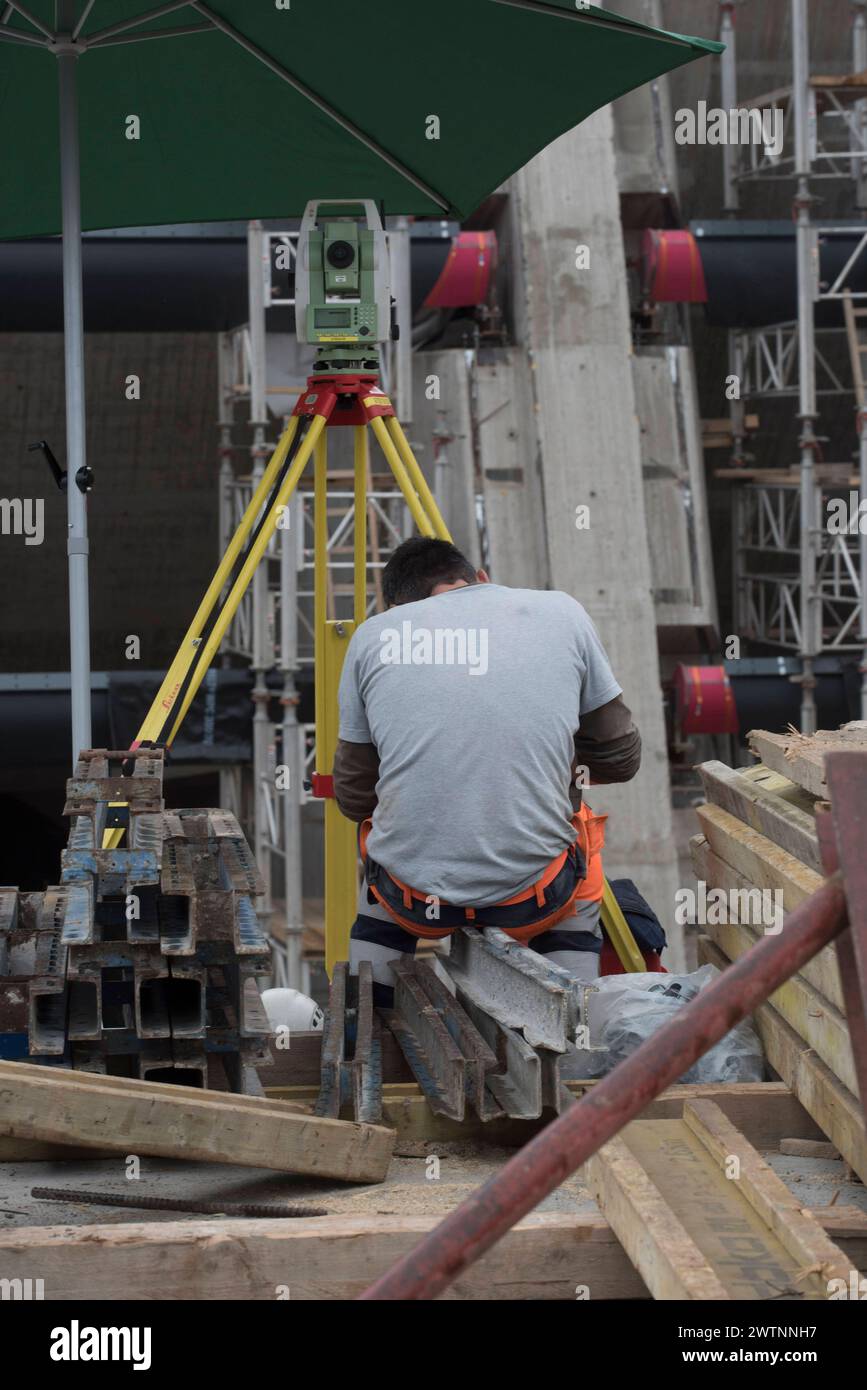 surveying by a land surveyor with measure instruments in geodesy surveying by a land surveyor in ...