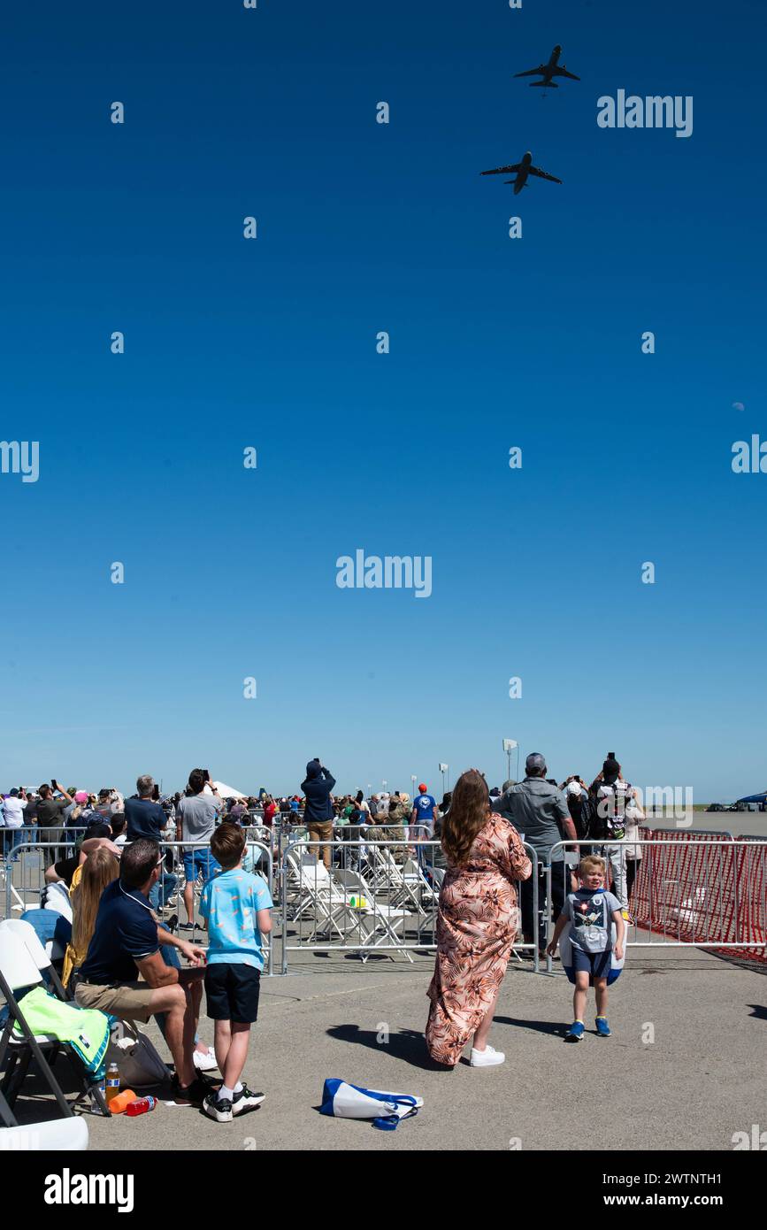 Families observe aircraft perform aerobatic maneuvers during the Travis ...