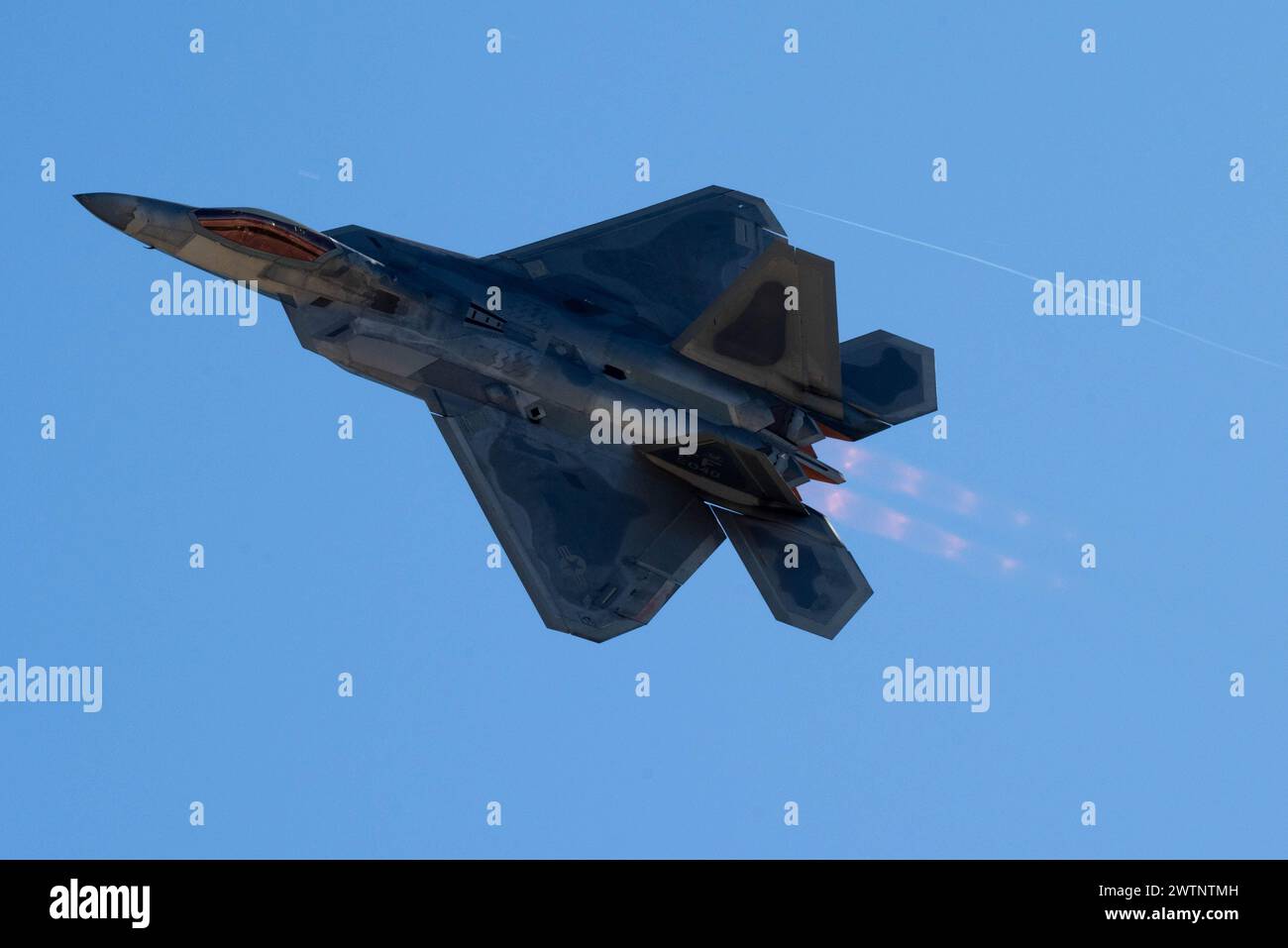 An F-22 Raptor performs aerobatic maneuvers during the Travis Air Force ...