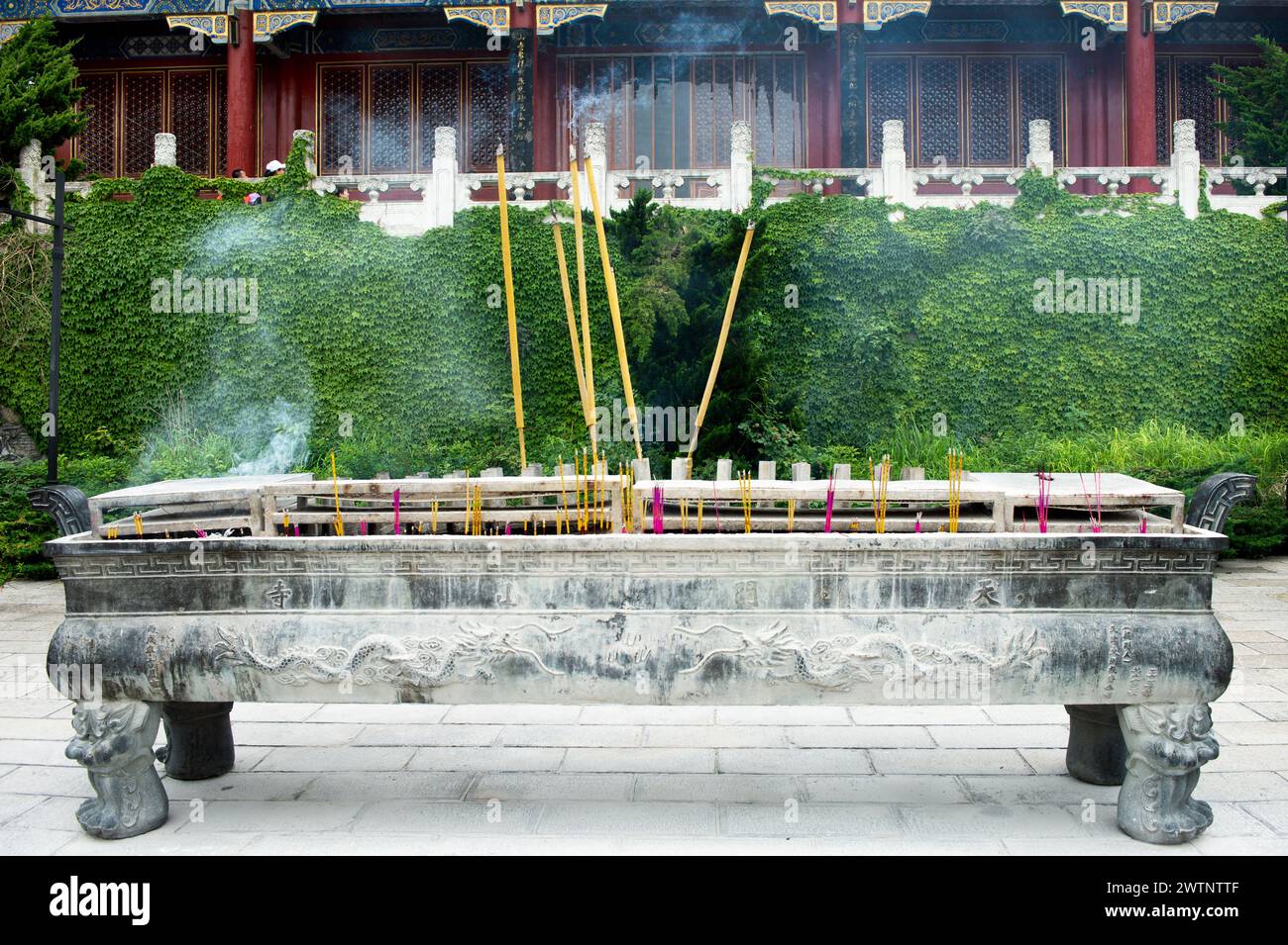 A stone table holds burning incense outside Tianmanshan Temple in ...