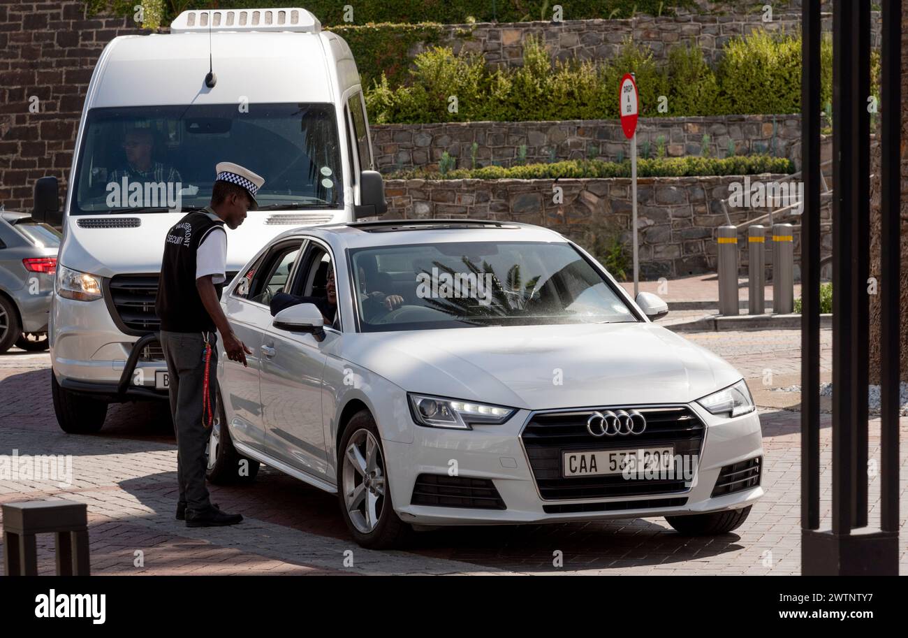 Cape Town South Africa. 18/03/2024. Security guard talking to a car driver in the waterfront ...