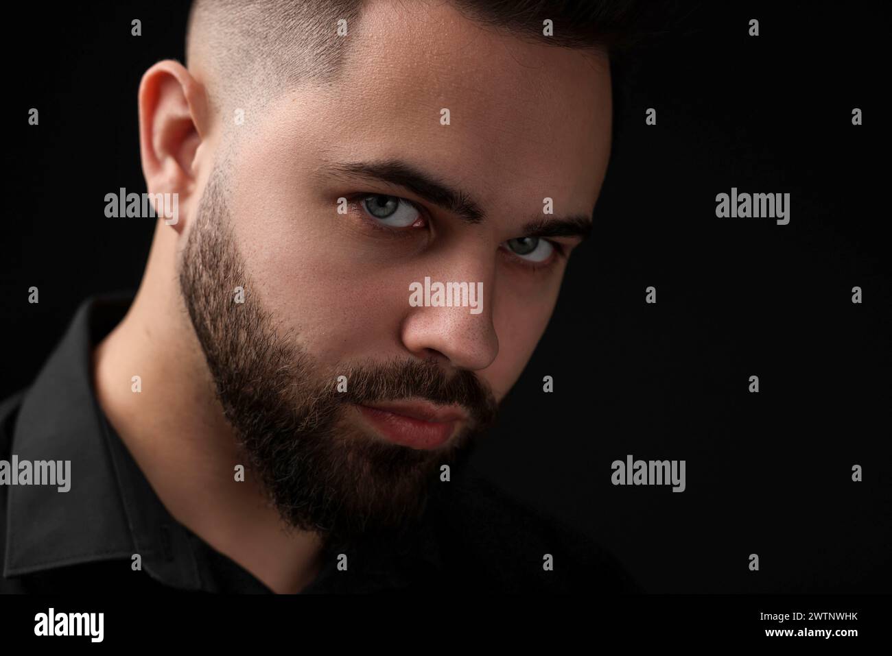 Evil eye. Man with scary eyes on black background, space for text Stock ...