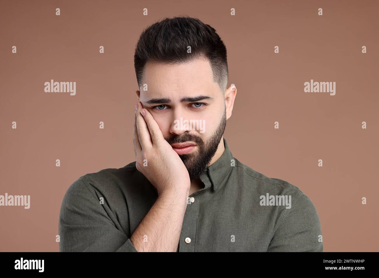 Portrait of sad man on brown background Stock Photo - Alamy