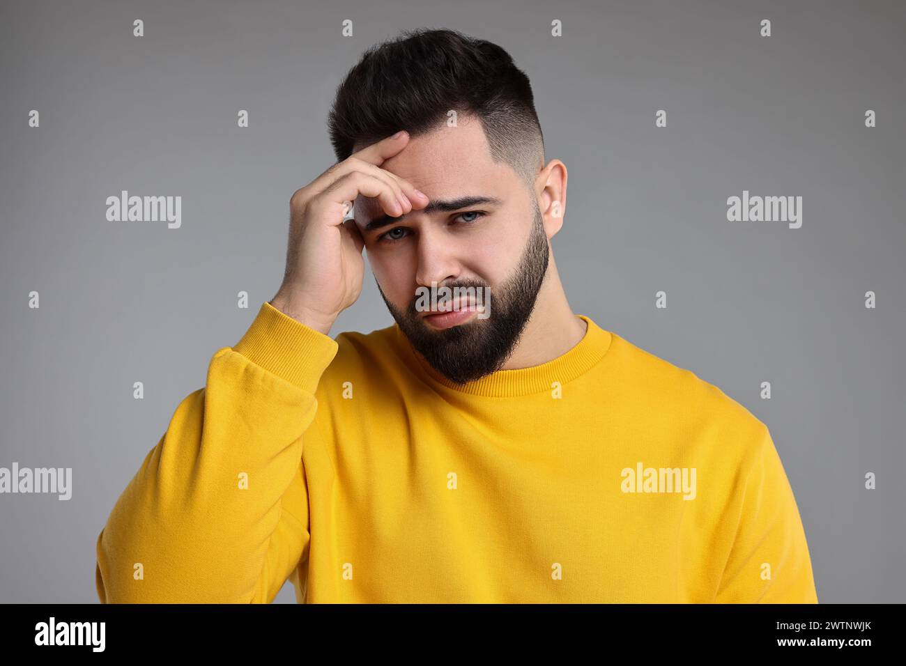 Portrait of sad man on light grey background Stock Photo - Alamy