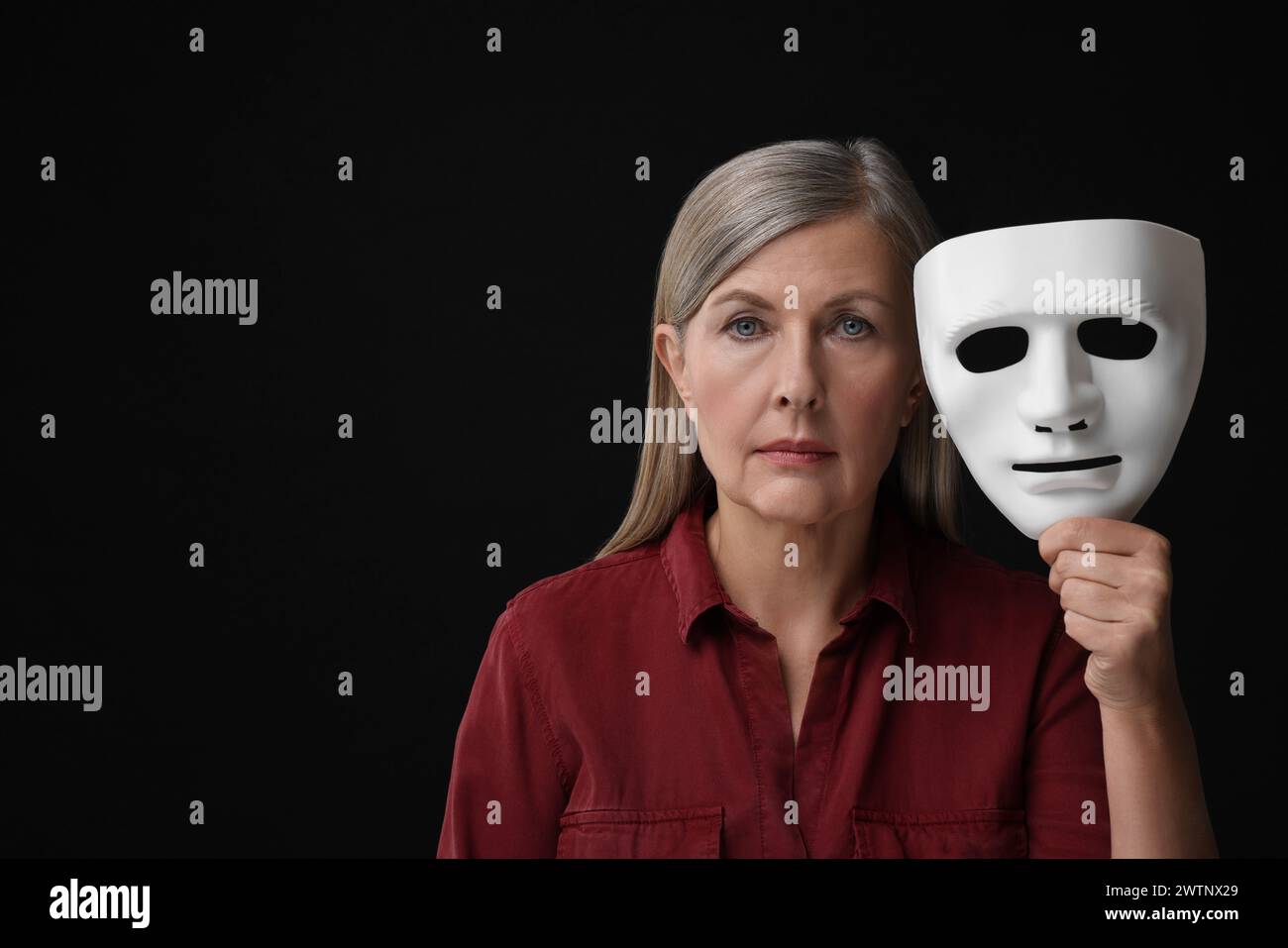 Multiple personality concept. Woman with mask on black background ...