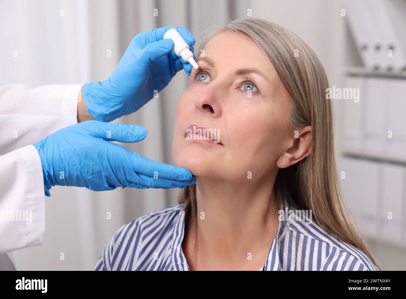 Female doctor dripping eye hi-res stock photography and images - Alamy