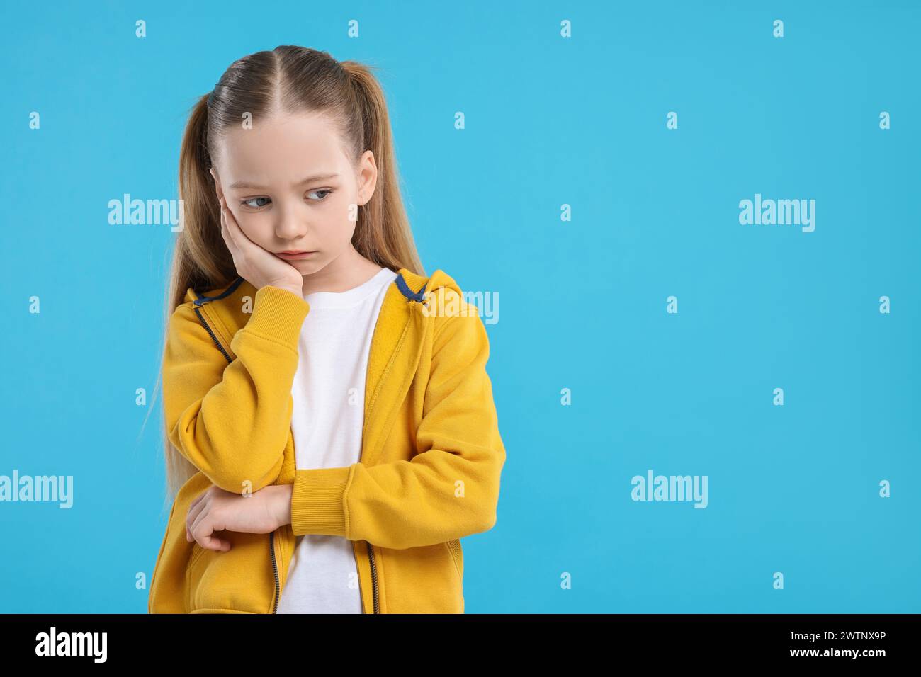 Portrait of sad girl on light blue background, space for text Stock ...