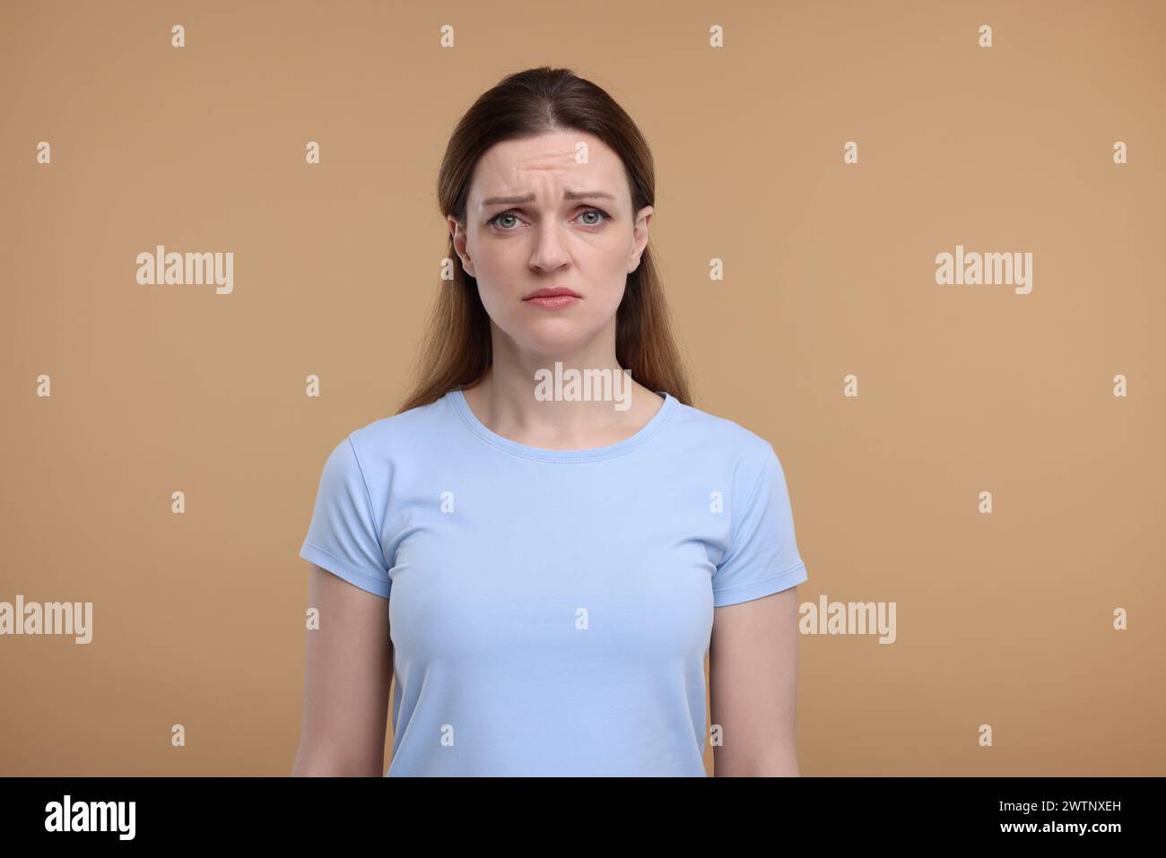 Depressed woman in beige hi-res stock photography and images - Alamy