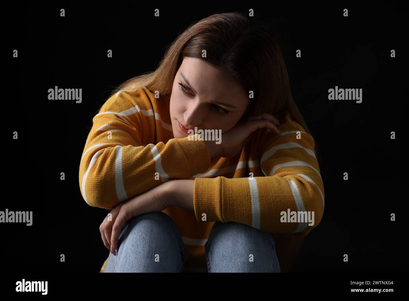 Portrait of sad woman on black background Stock Photo - Alamy