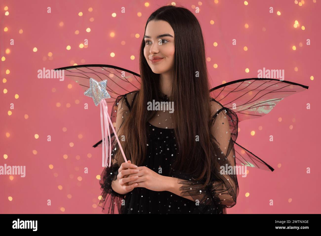 Beautiful girl in fairy costume with wings and magic wand on pink ...