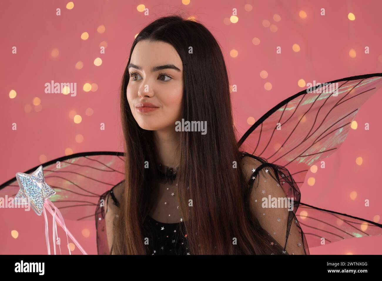 Beautiful girl in fairy costume with wings and magic wand on pink ...