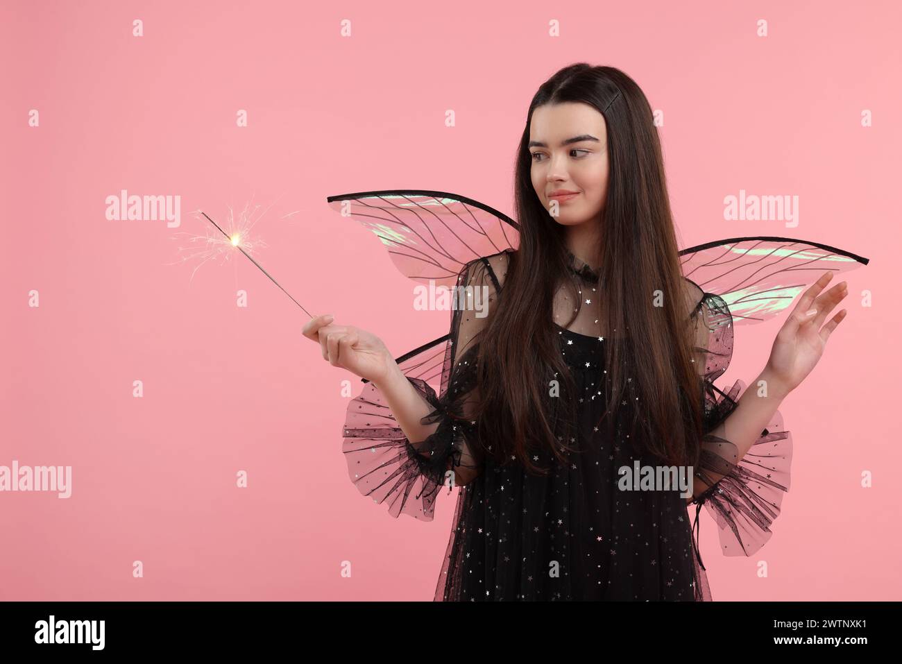 Beautiful girl in fairy costume with wings and magic wand on pink ...