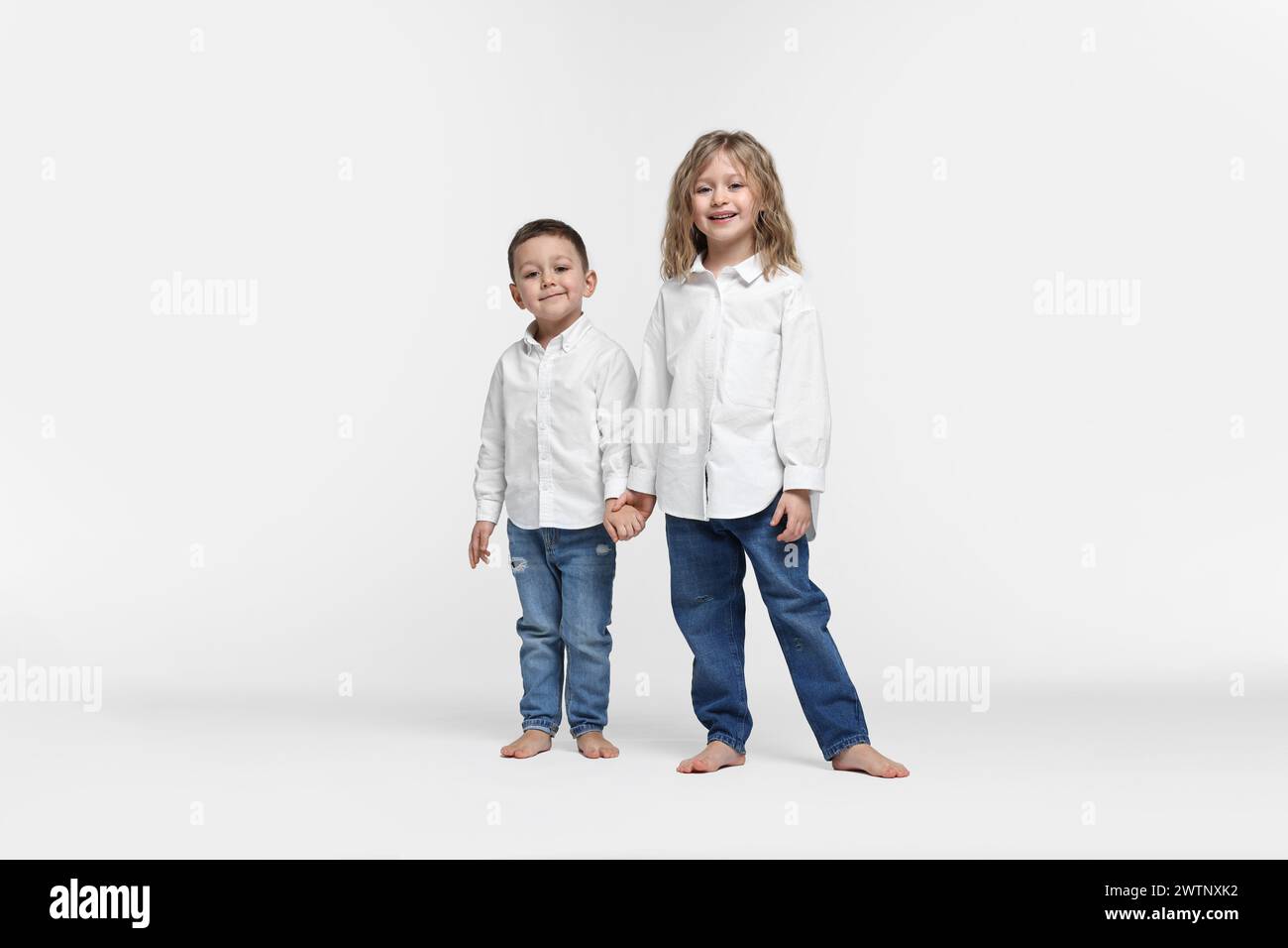 Cute little children on white background. Happy family Stock Photo - Alamy