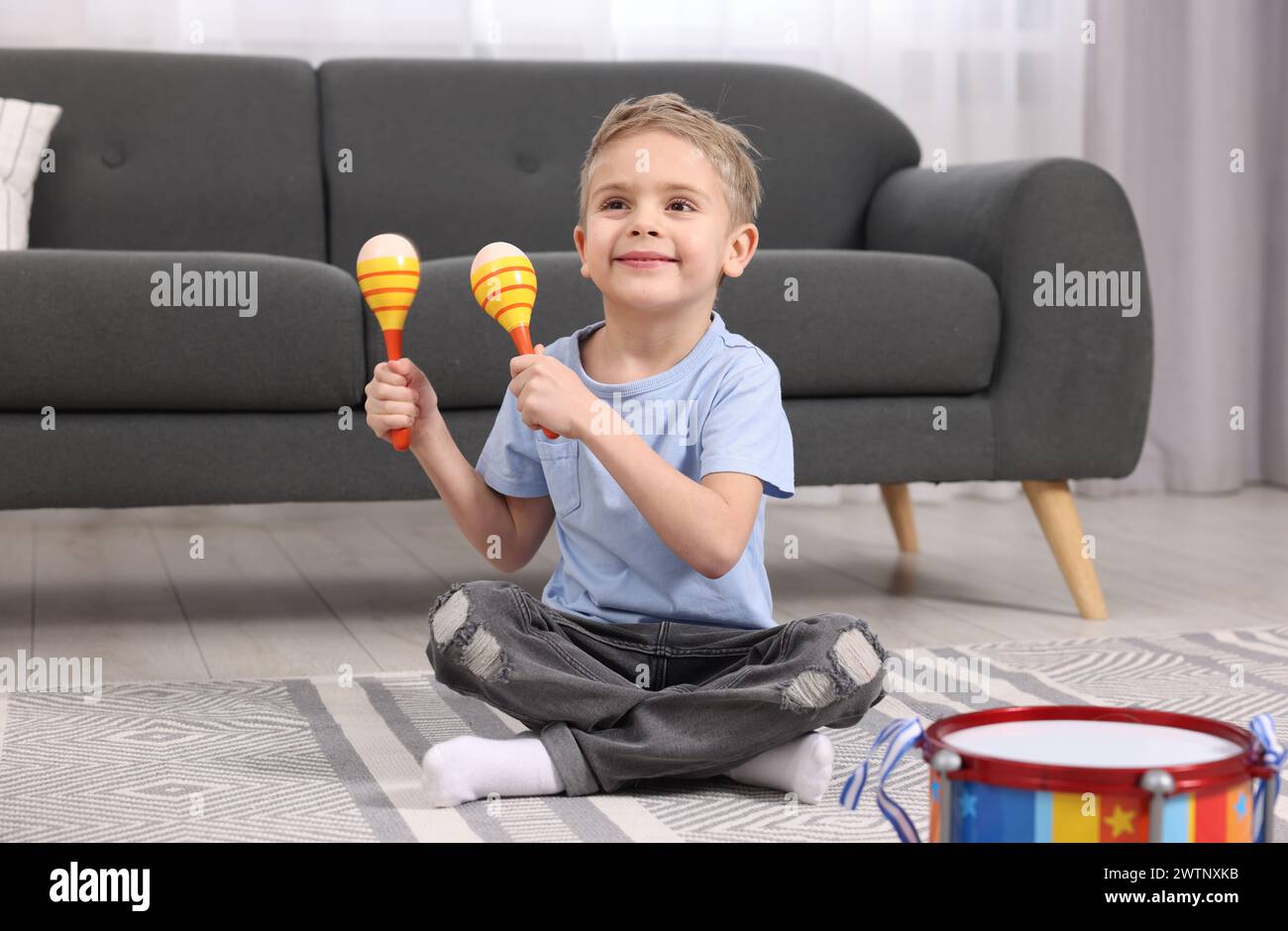 Little boy playing toy maracas at home Stock Photo - Alamy