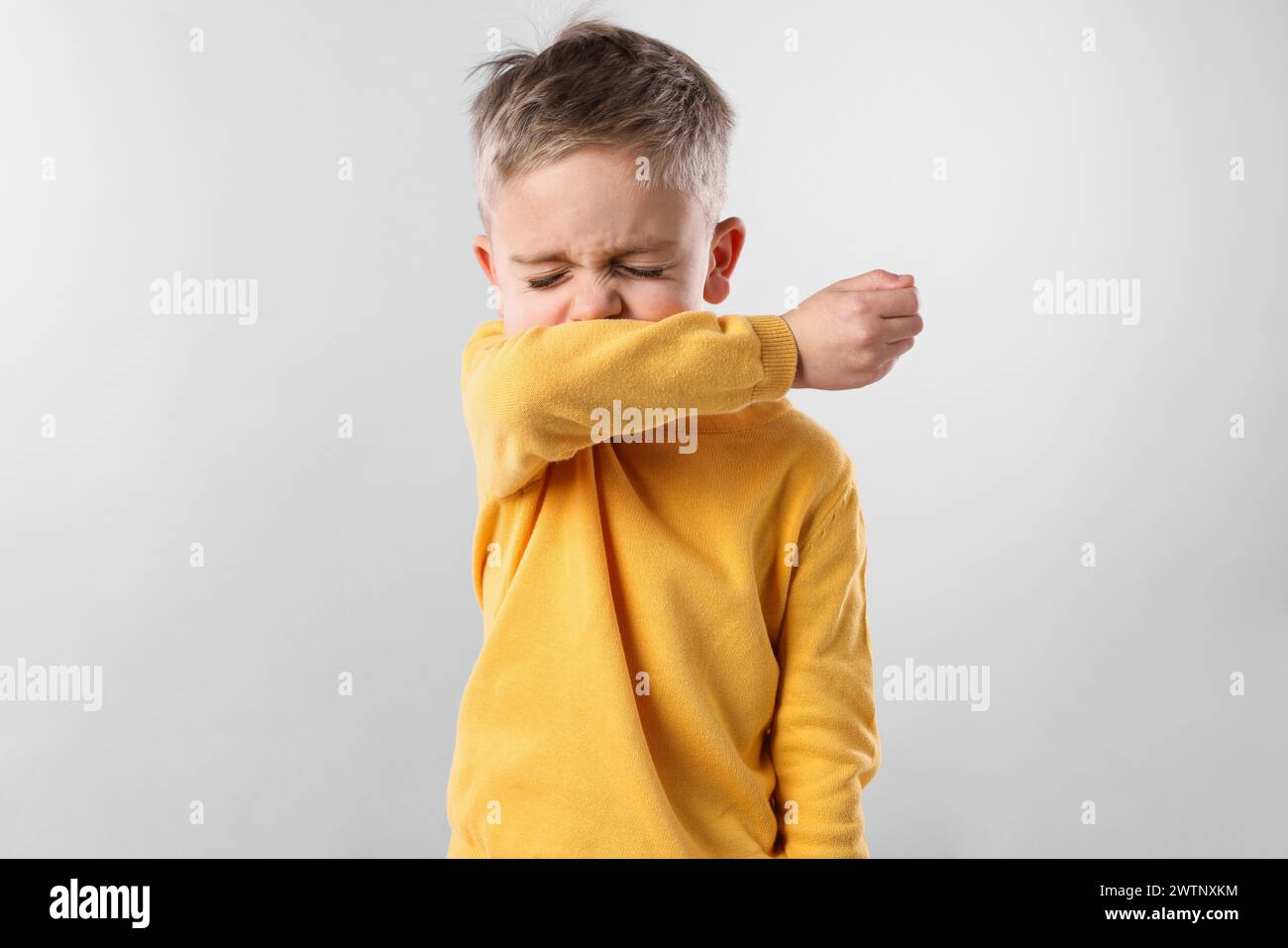 Sick boy coughing on gray background. Cold symptoms Stock Photo - Alamy