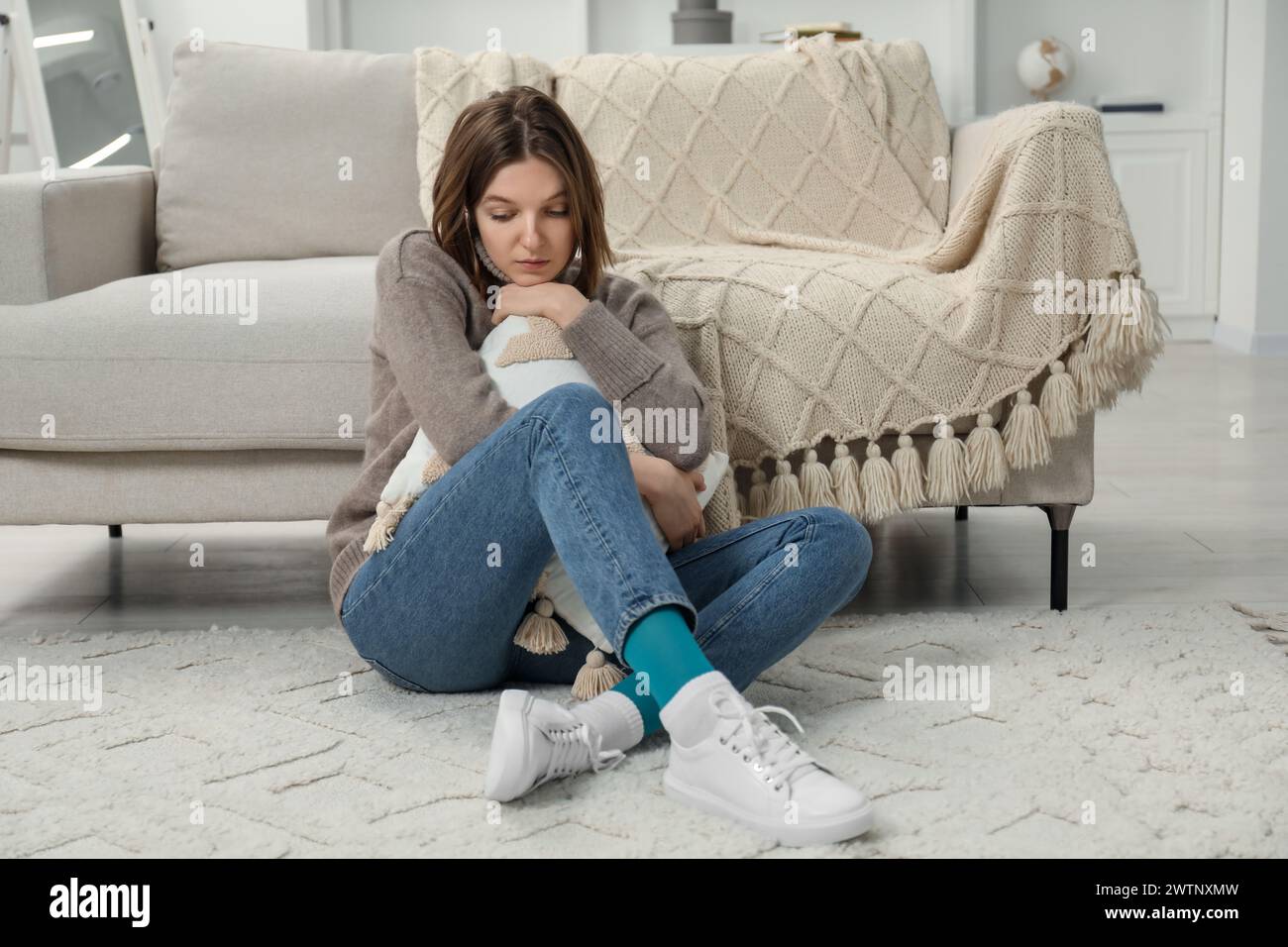 Young sad woman sitting on floor hi-res stock photography and images ...