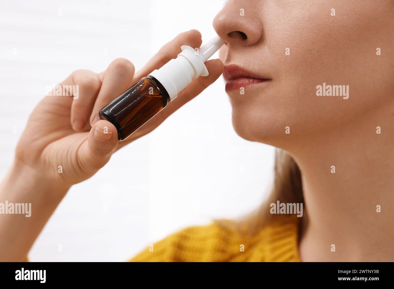 Medical drops. Young woman using nasal spray indoors, closeup Stock ...