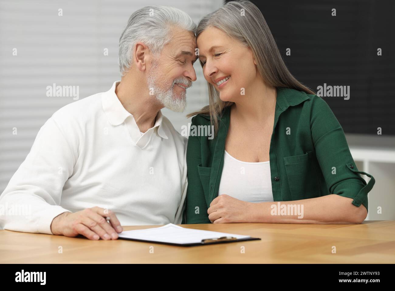 Happy family couple signing hi-res stock photography and images - Alamy