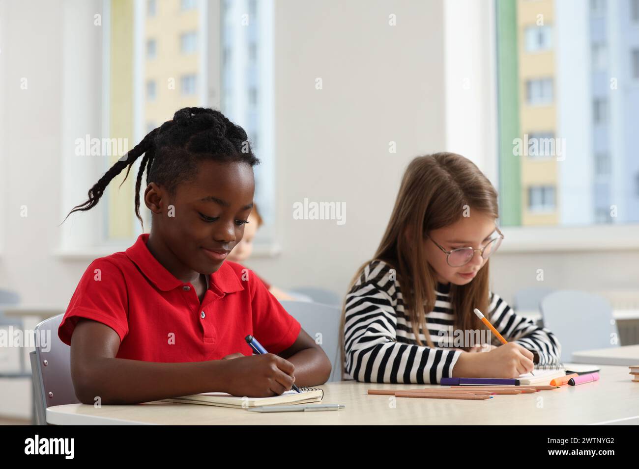 Cute children studying in classroom at school Stock Photo - Alamy
