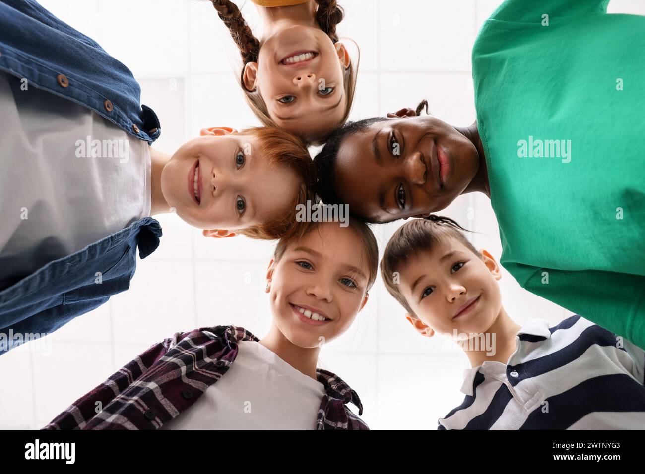 Happy children huddling at school, bottom view Stock Photo - Alamy