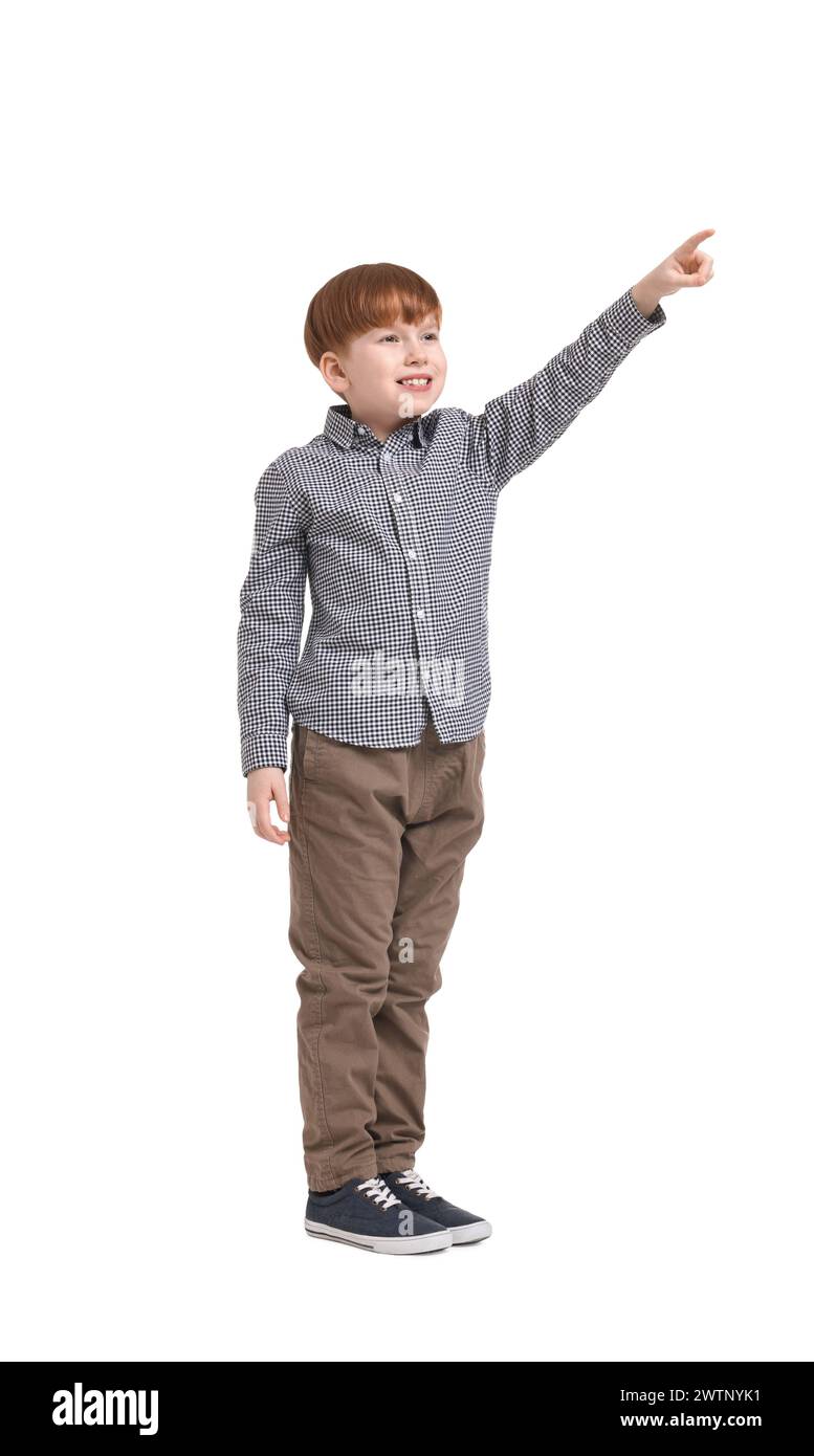 Little boy pointing at something on white background Stock Photo - Alamy