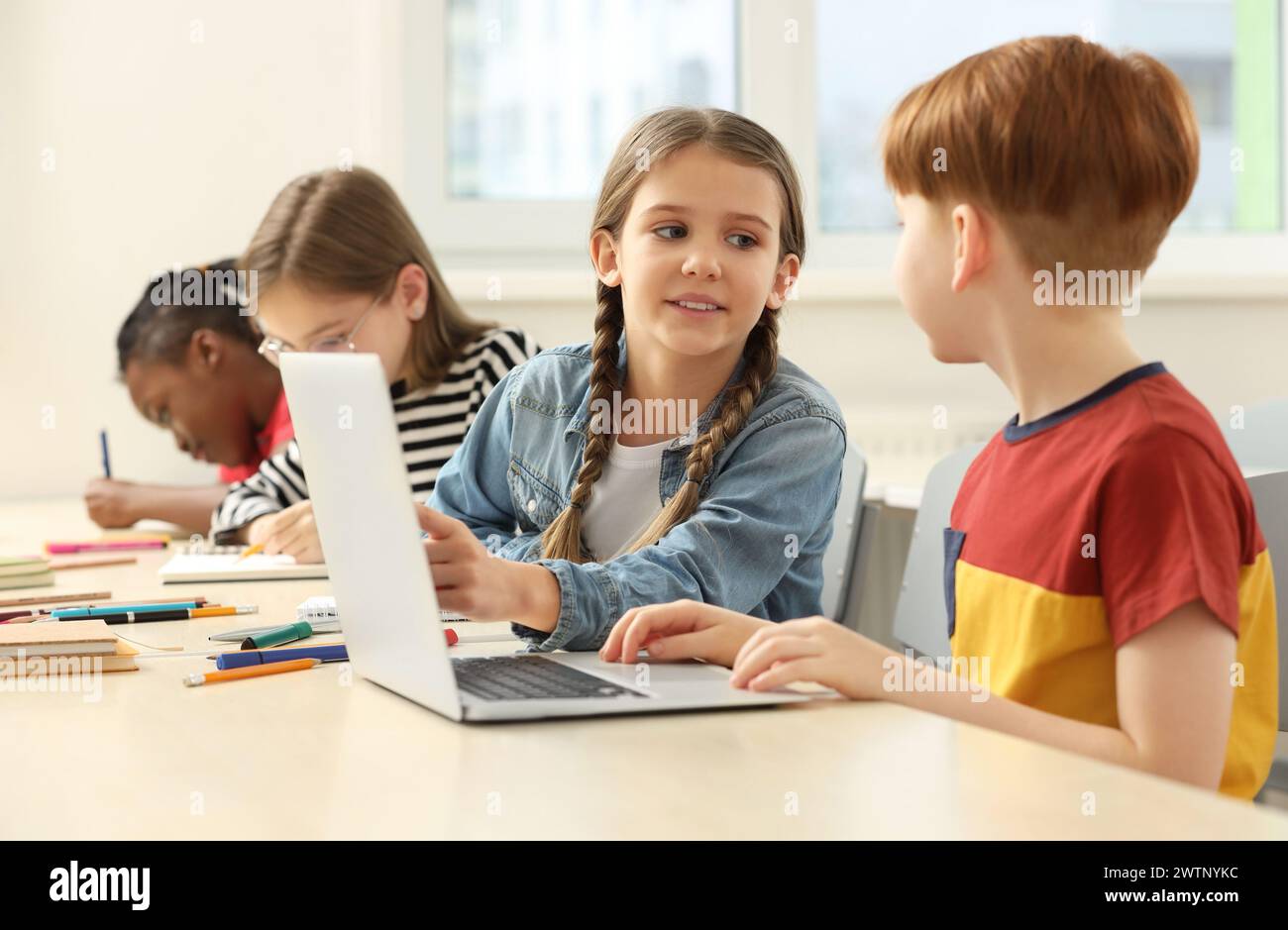 Cute children studying in classroom at school Stock Photo - Alamy