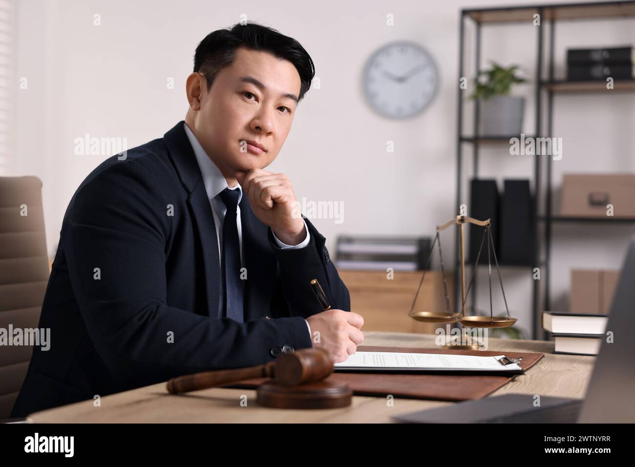 Notary writing notes at wooden table in office Stock Photo - Alamy