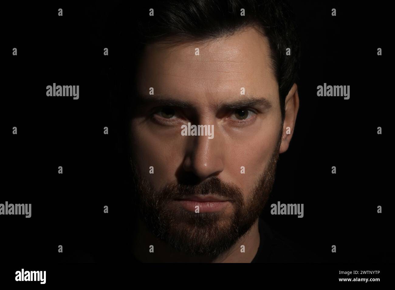 Evil eye. Man with scary eyes in darkness, closeup Stock Photo - Alamy