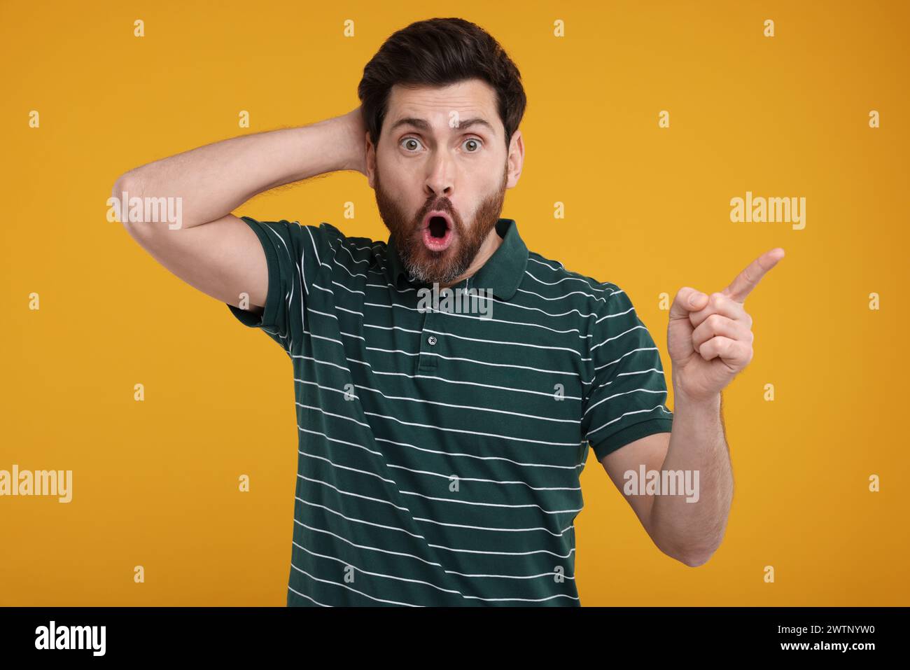 Surprised man pointing text hi-res stock photography and images - Alamy