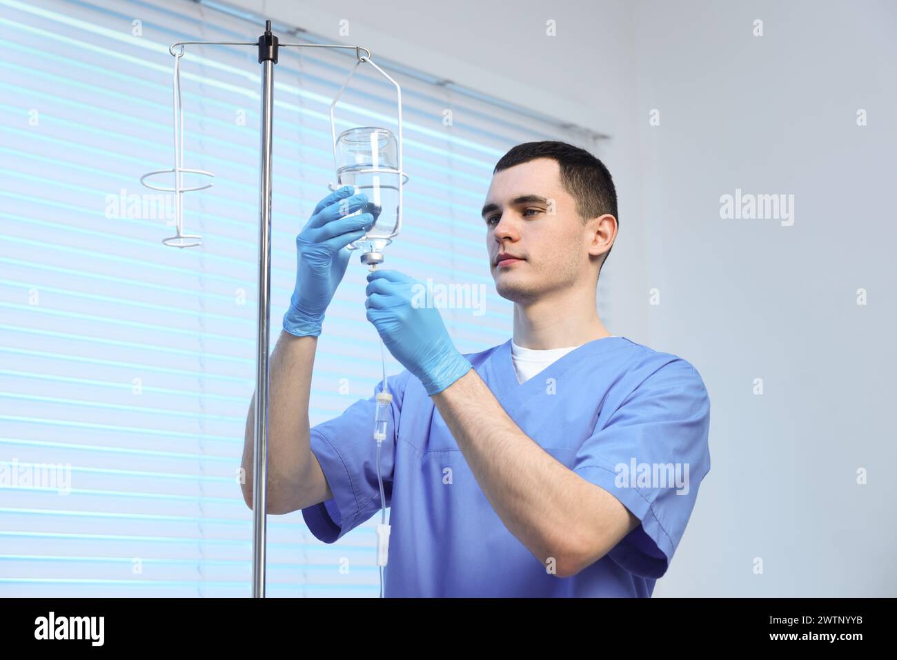 Nurse setting up IV drip in hospital Stock Photo - Alamy