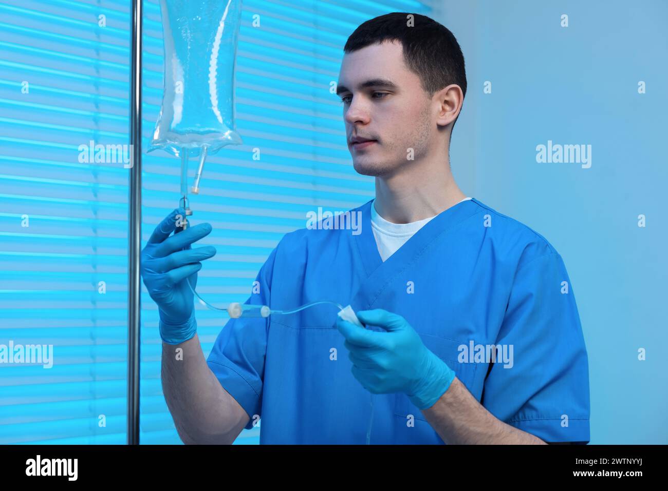Nurse setting up IV drip in hospital Stock Photo - Alamy