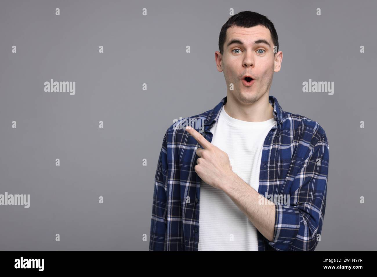 Surprised man pointing text hi-res stock photography and images - Alamy