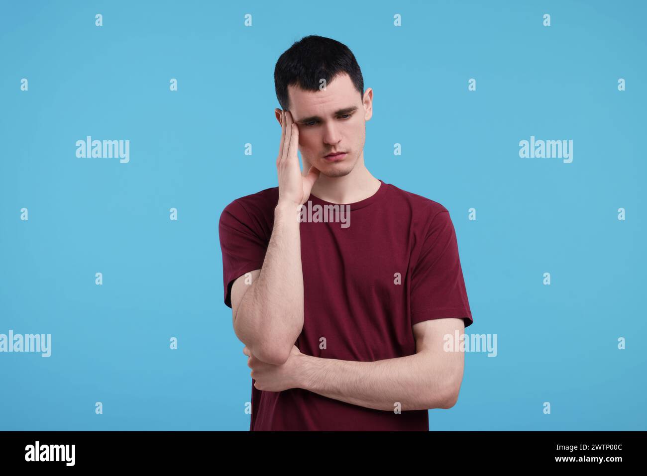 Portrait of sad man on light blue background Stock Photo - Alamy