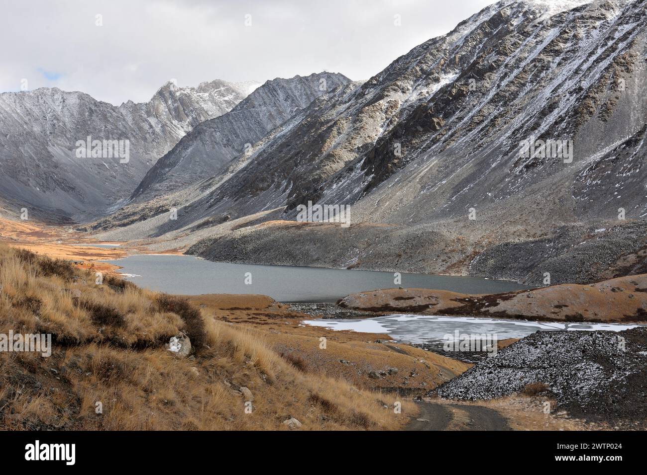 A view from the top to a chain of lakes in a narrow valley sandwiched ...