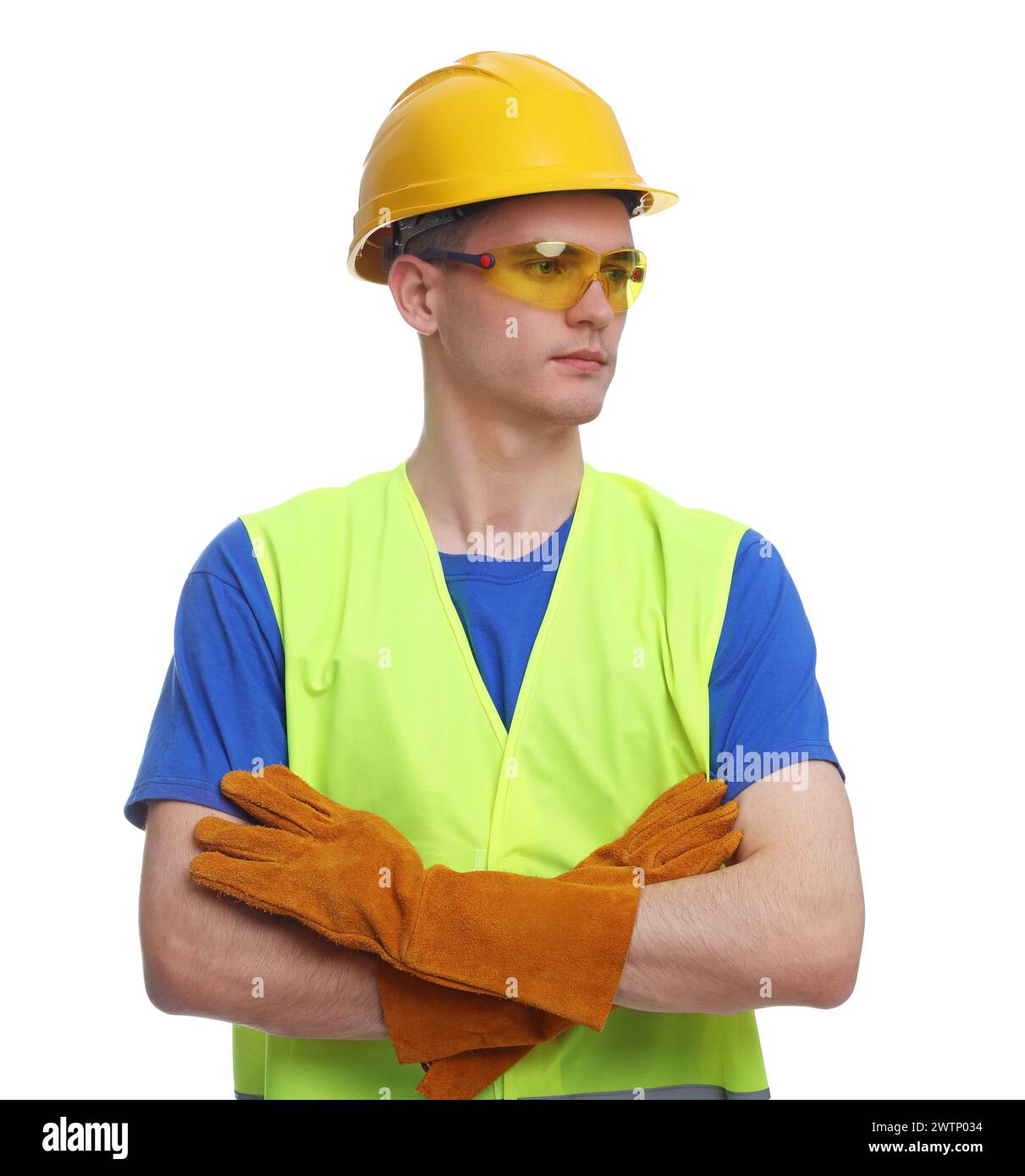 Young man with crossed arms wearing safety equipment on white ...