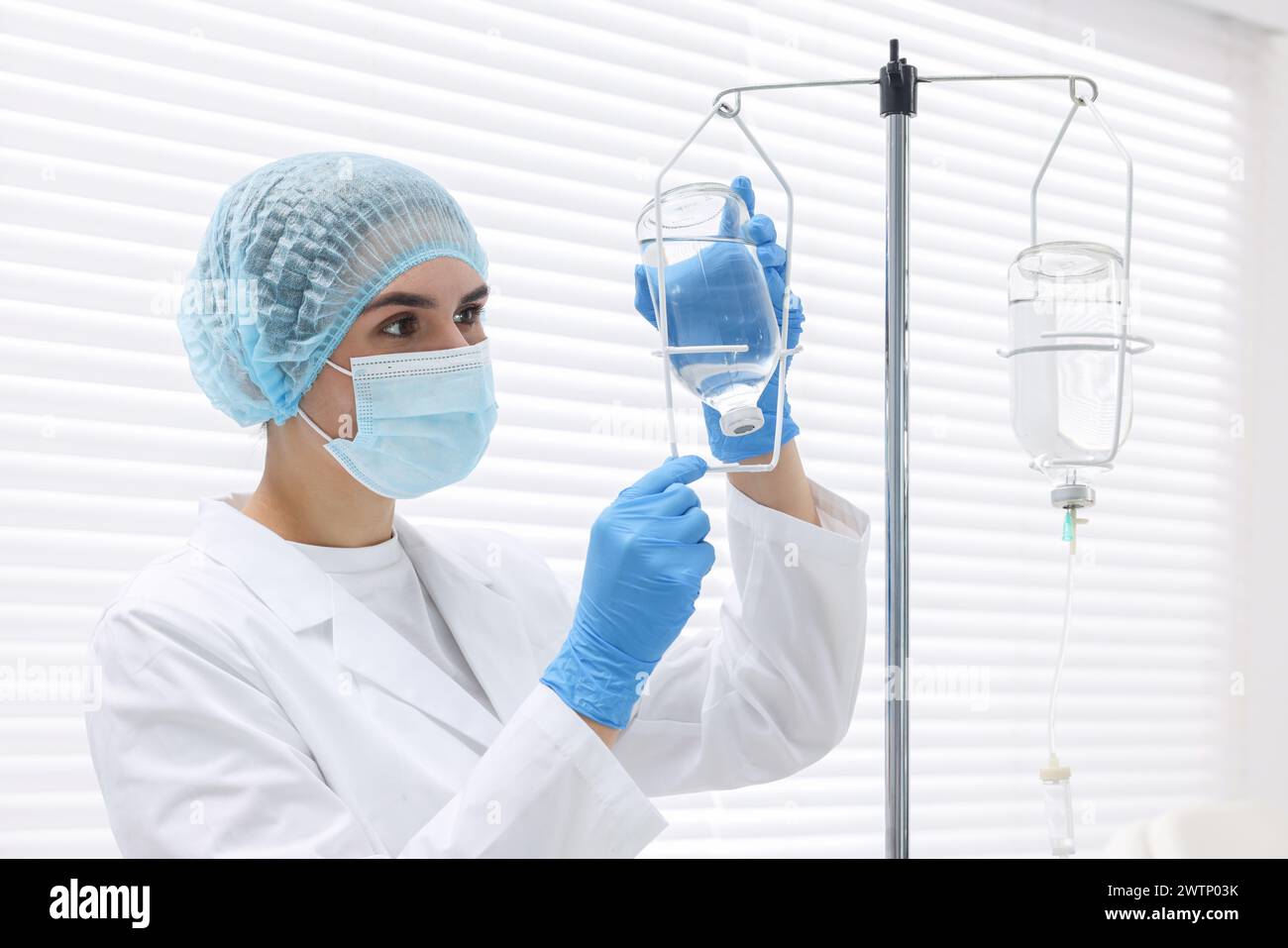 Nurse setting up IV drip in hospital Stock Photo - Alamy