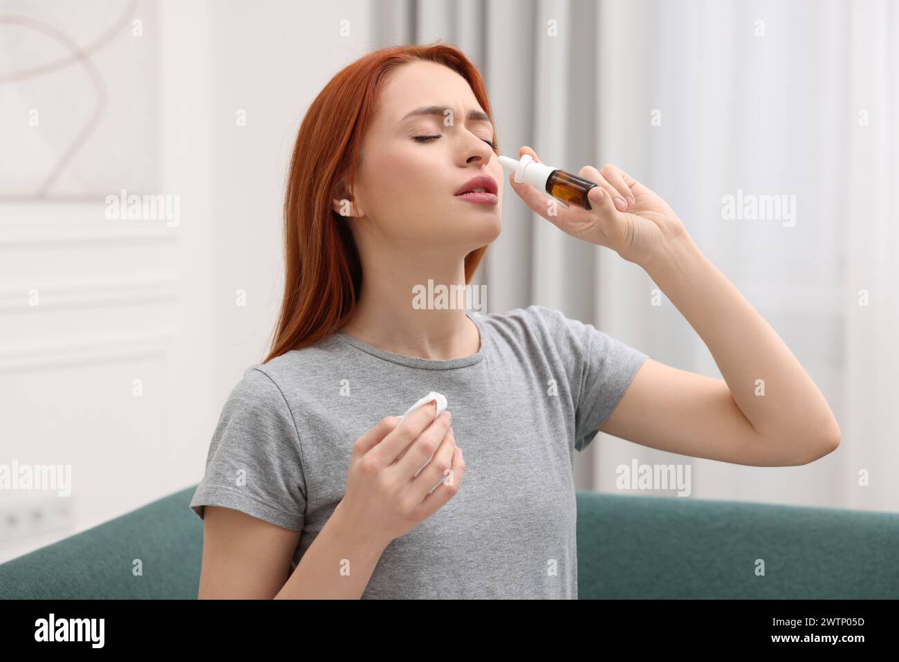 Medical drops. Woman with tissue using nasal spray at home Stock Photo ...
