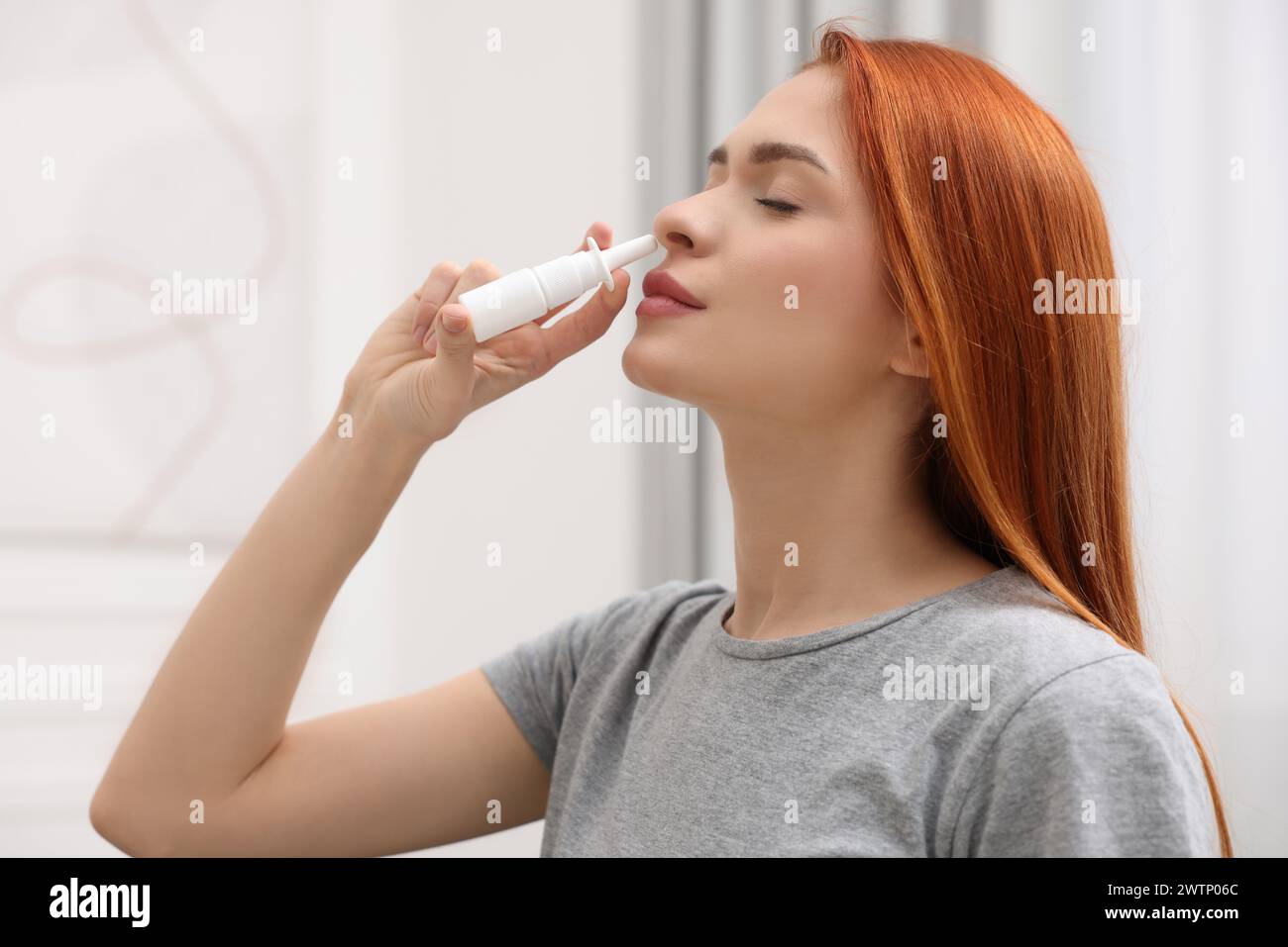 Medical drops. Woman using nasal spray at home Stock Photo - Alamy