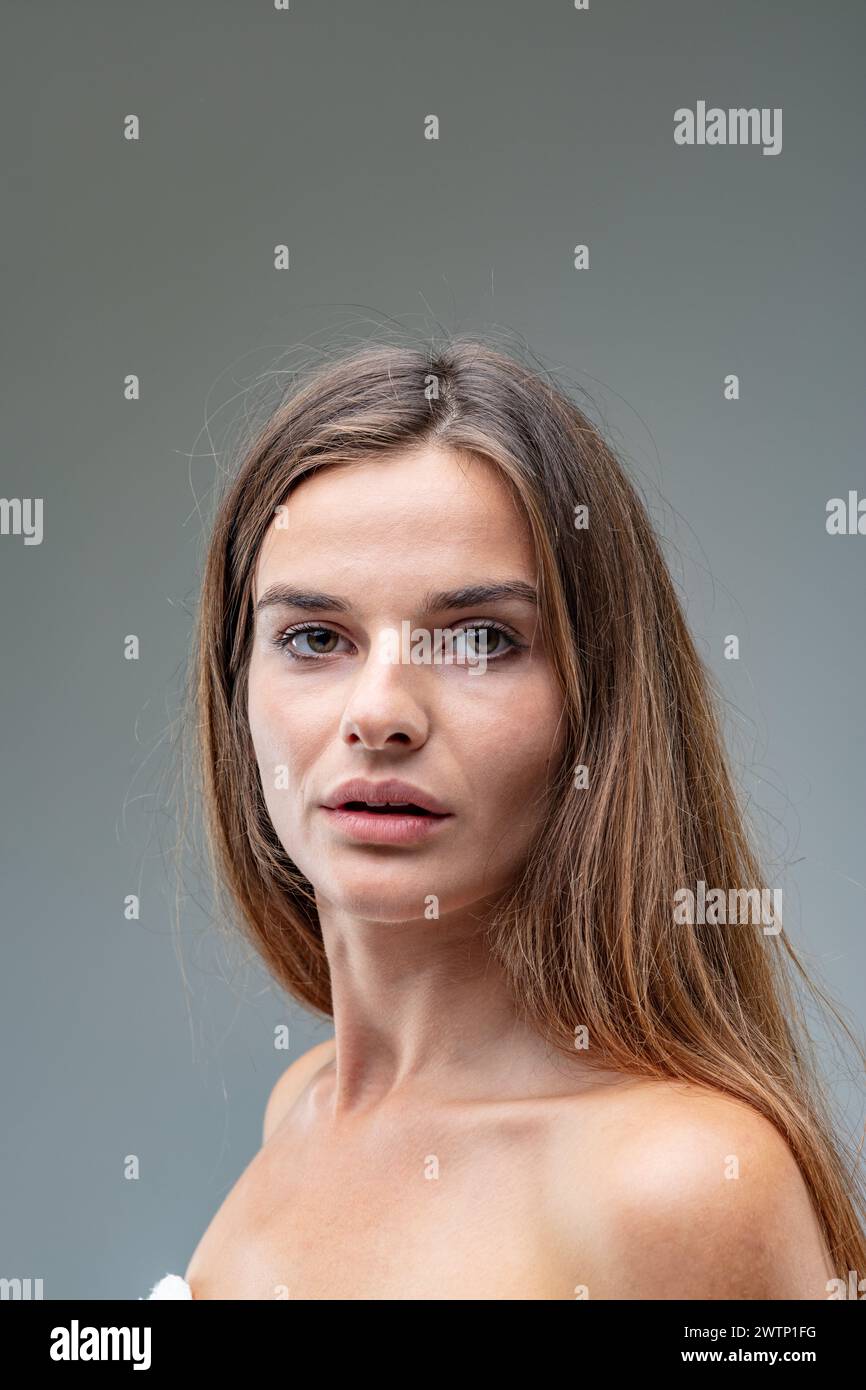 Woman with a contemplative gaze portrays a depth of unspoken emotions ...