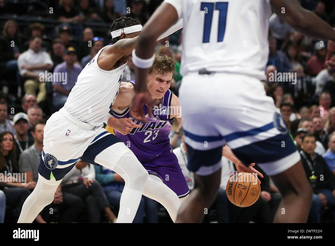 Utah Jazz forward Lauri Markkanen (23), center, dribbles through the defense of Minnesota ...