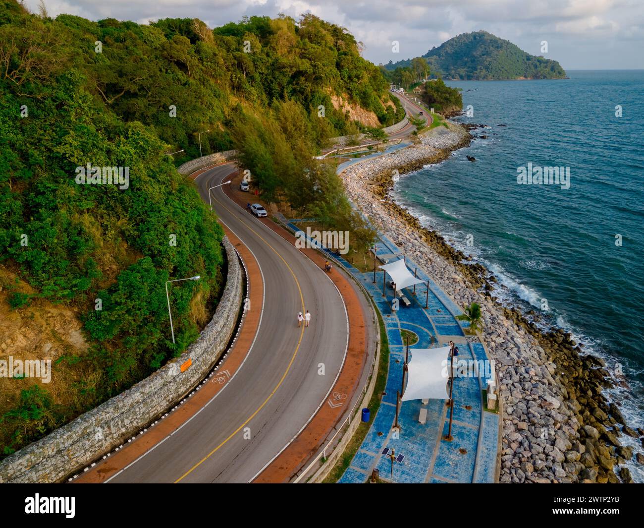 car driving on the curved road of Thailand. road landscape in summer. it's nice to drive on the ...