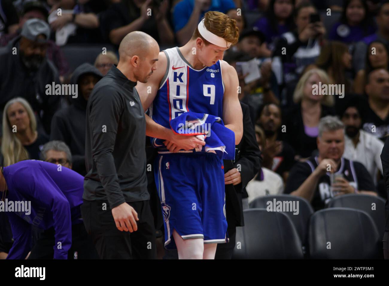Sacramento Kings guard Kevin Huerter (9) is escorted off the court with ...