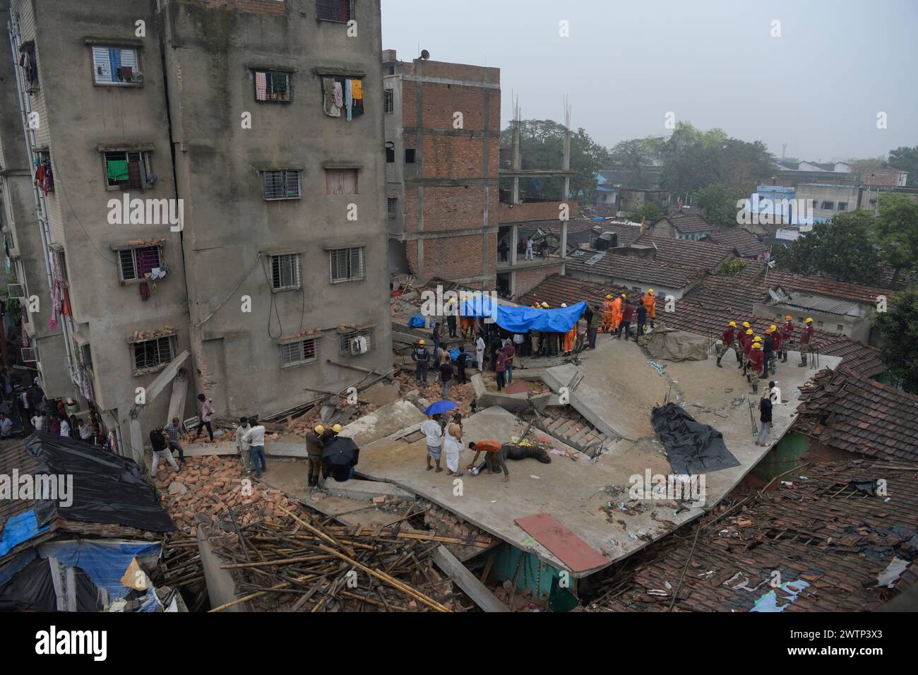 Members of the National Disaster Response Force (NDRF) team search for ...
